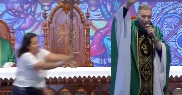 Woman in Brazil shoves anti-gay priest off stage in viral video